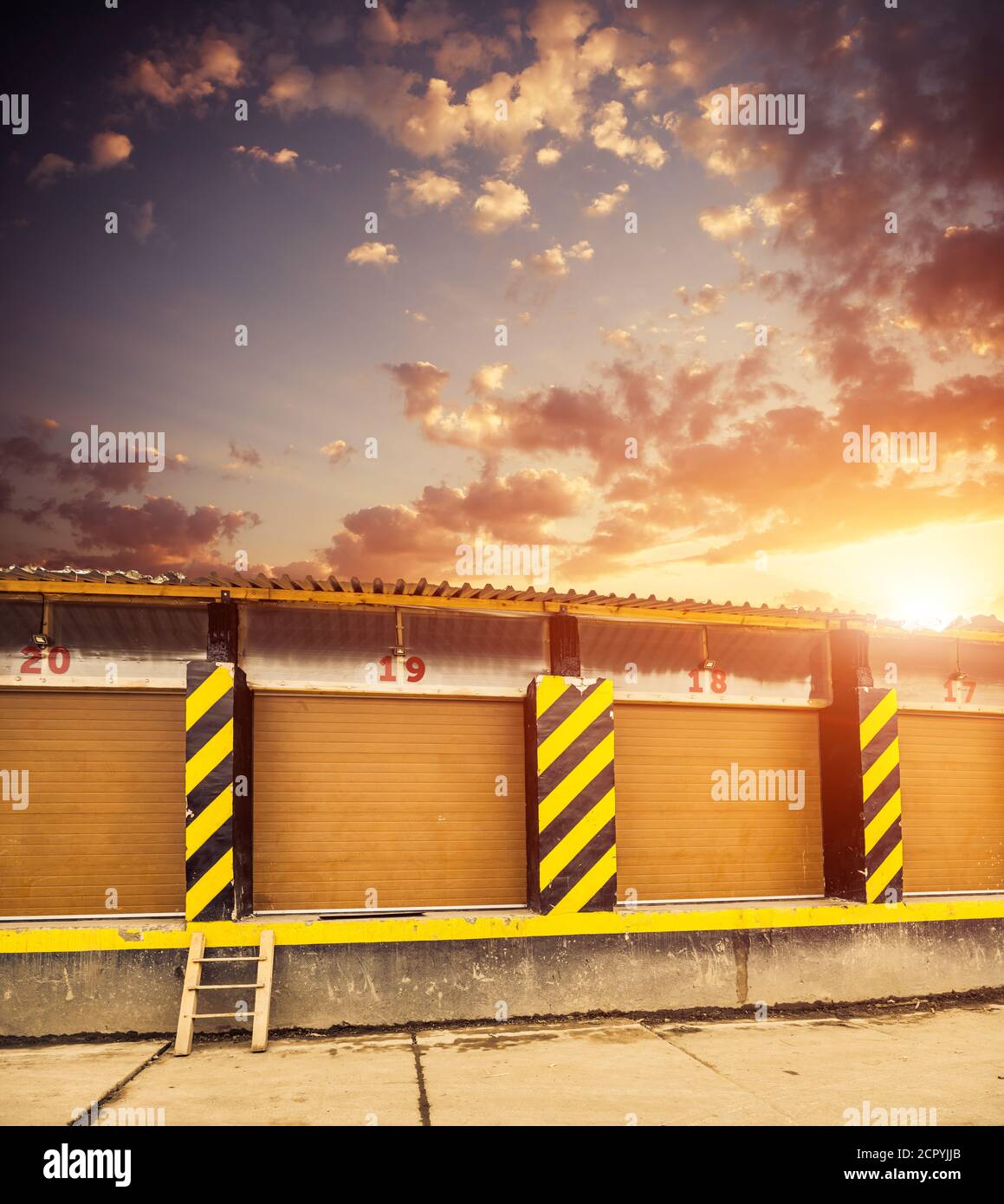 Old storage building with ramp at sunset sky background Stock Photo - Alamy