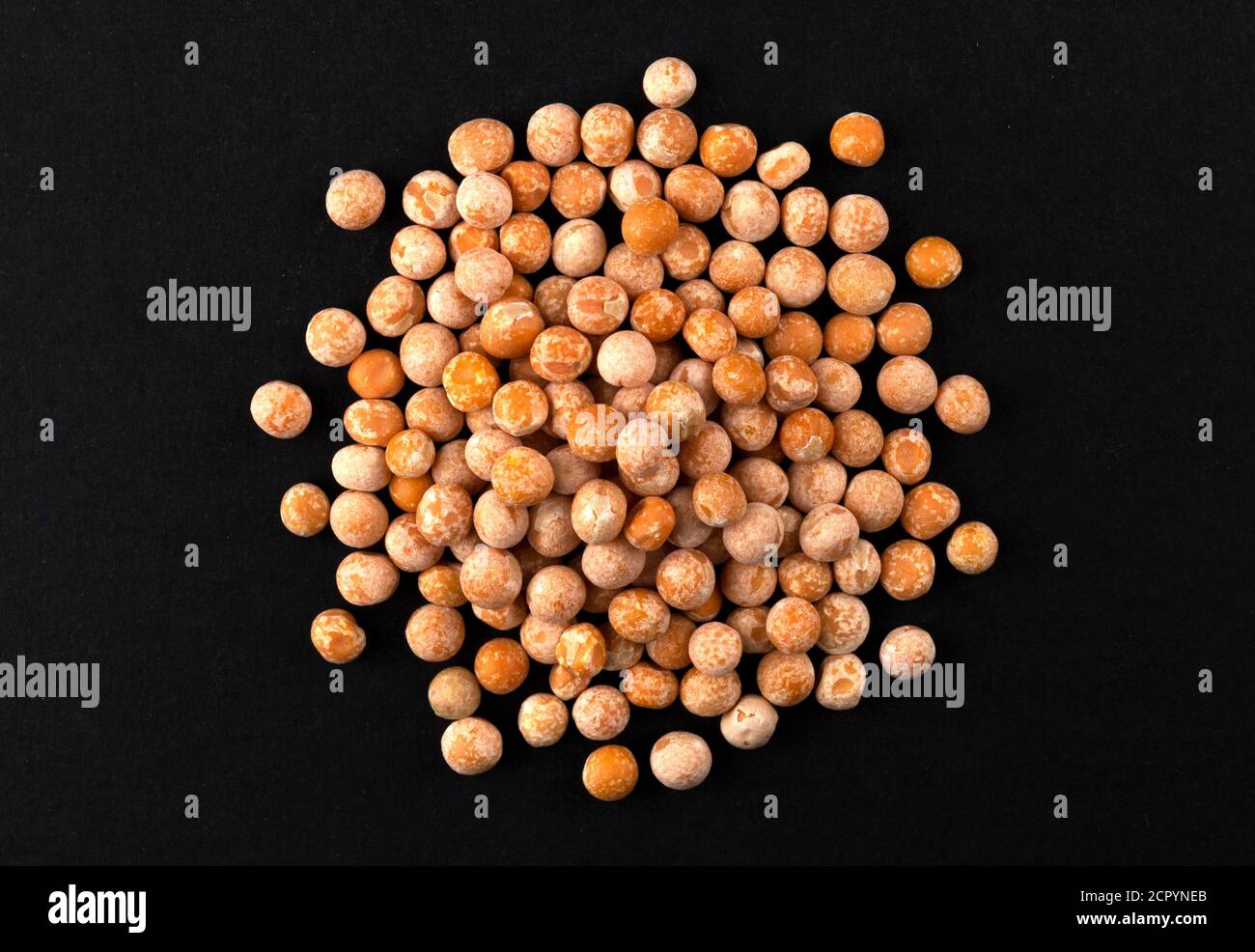 Heap of dried yellow pea isolated on black background Stock Photo - Alamy