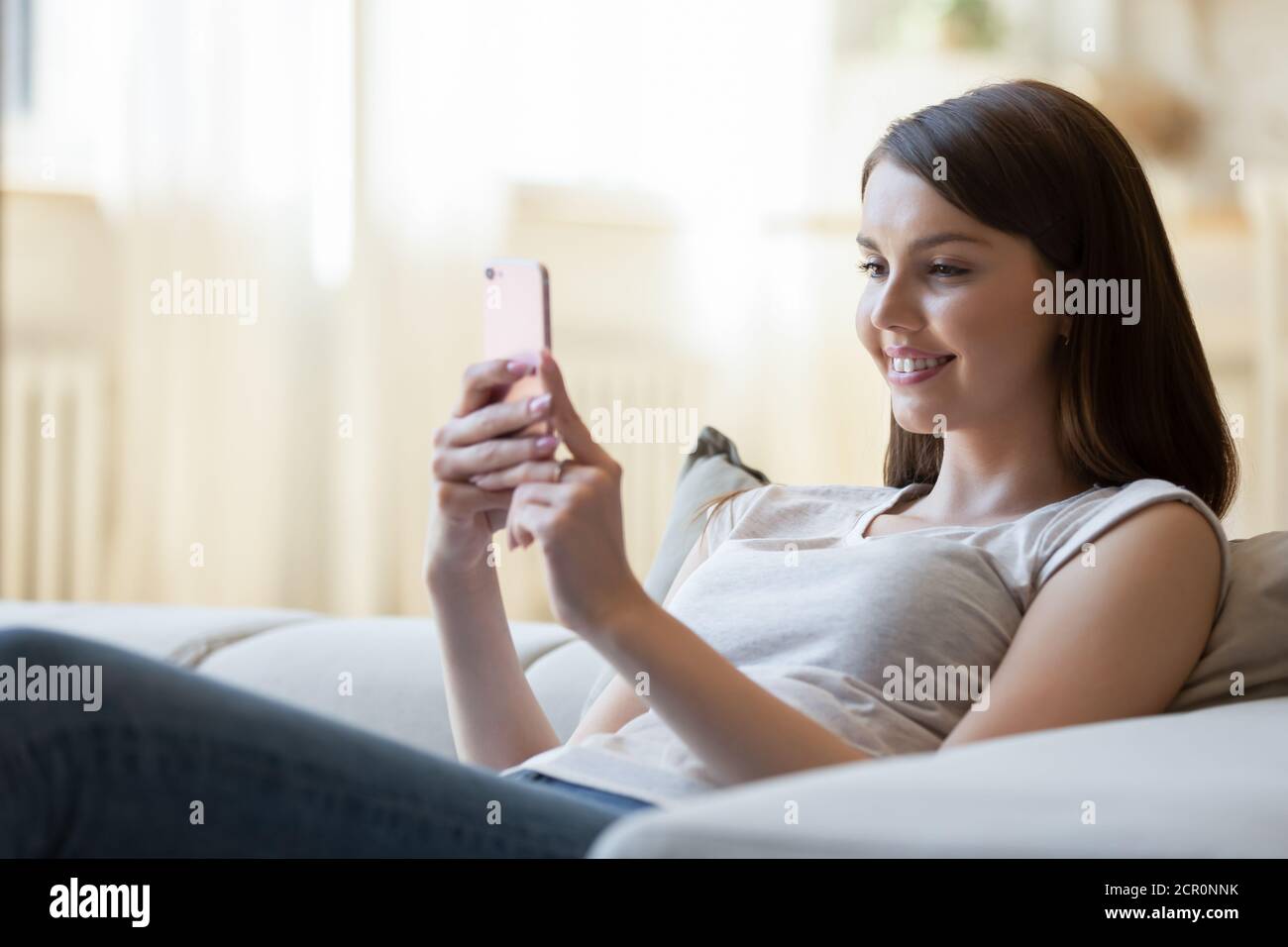 Woman home using cell hi-res stock photography and images - Alamy