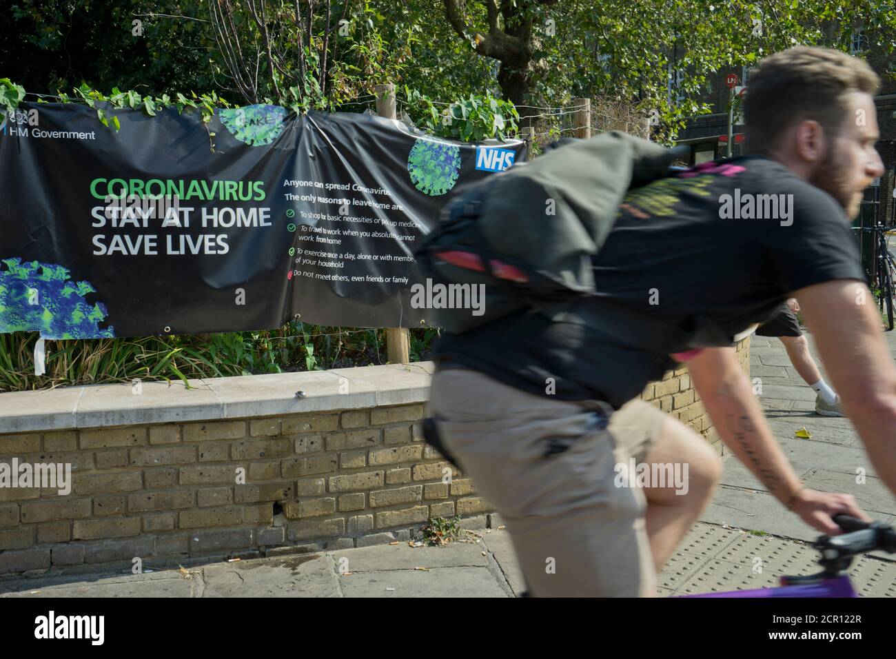Visitors to Broadway Market, with street signs advising to keep safe ...