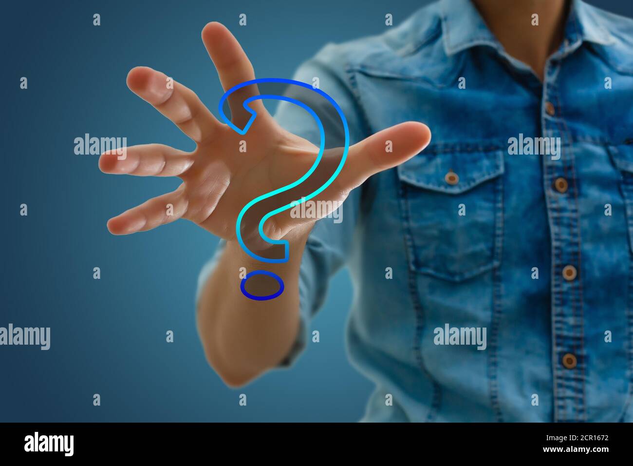 Businessman on blurred background touching hand drawn question marks ...