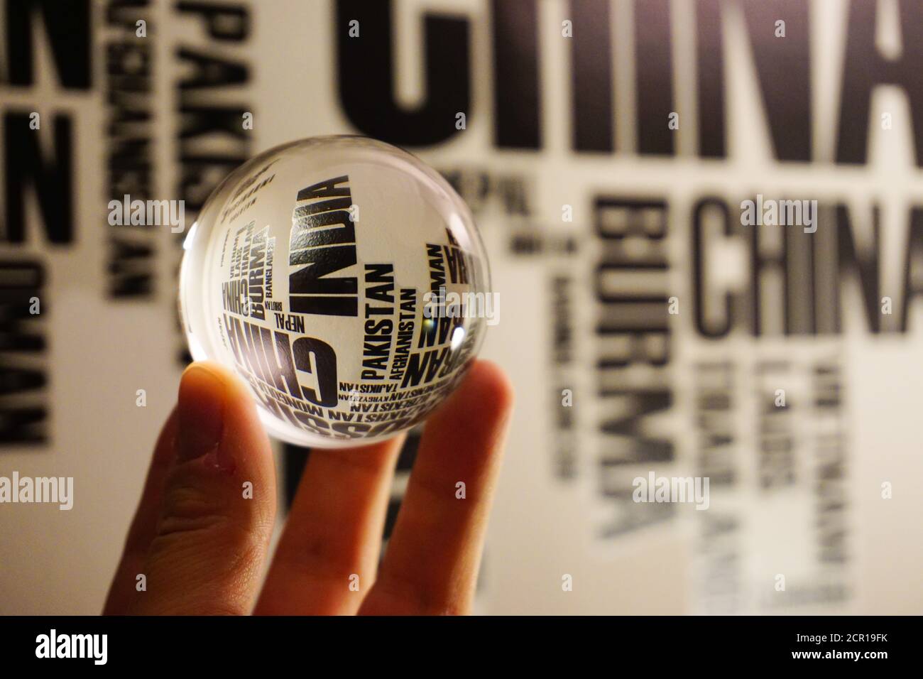Glass sphere with reverse reflection in hand Stock Photo - Alamy