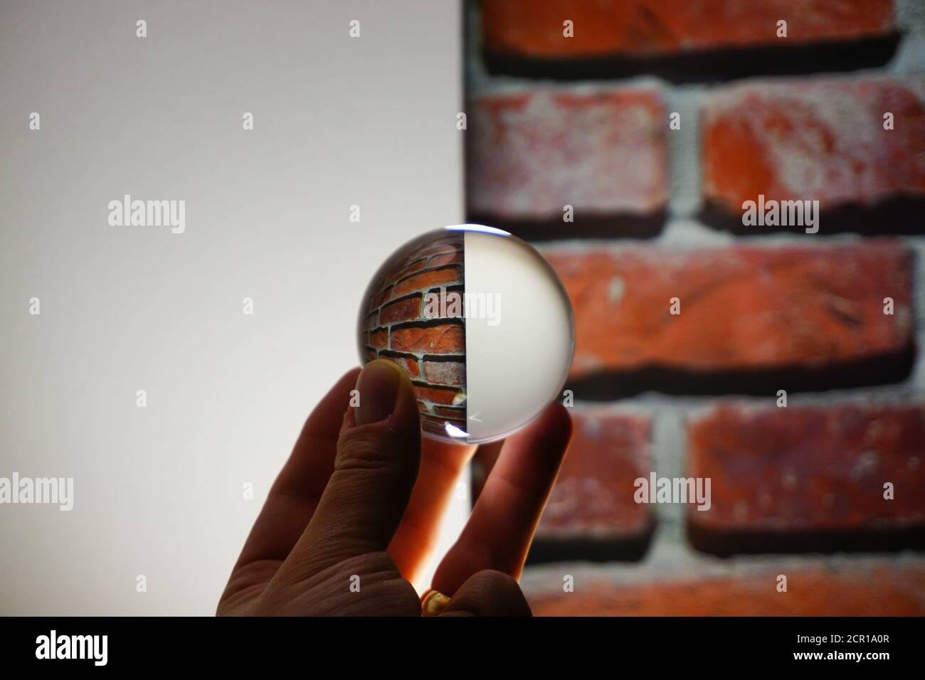 Glass sphere with reverse reflection in hand Stock Photo - Alamy