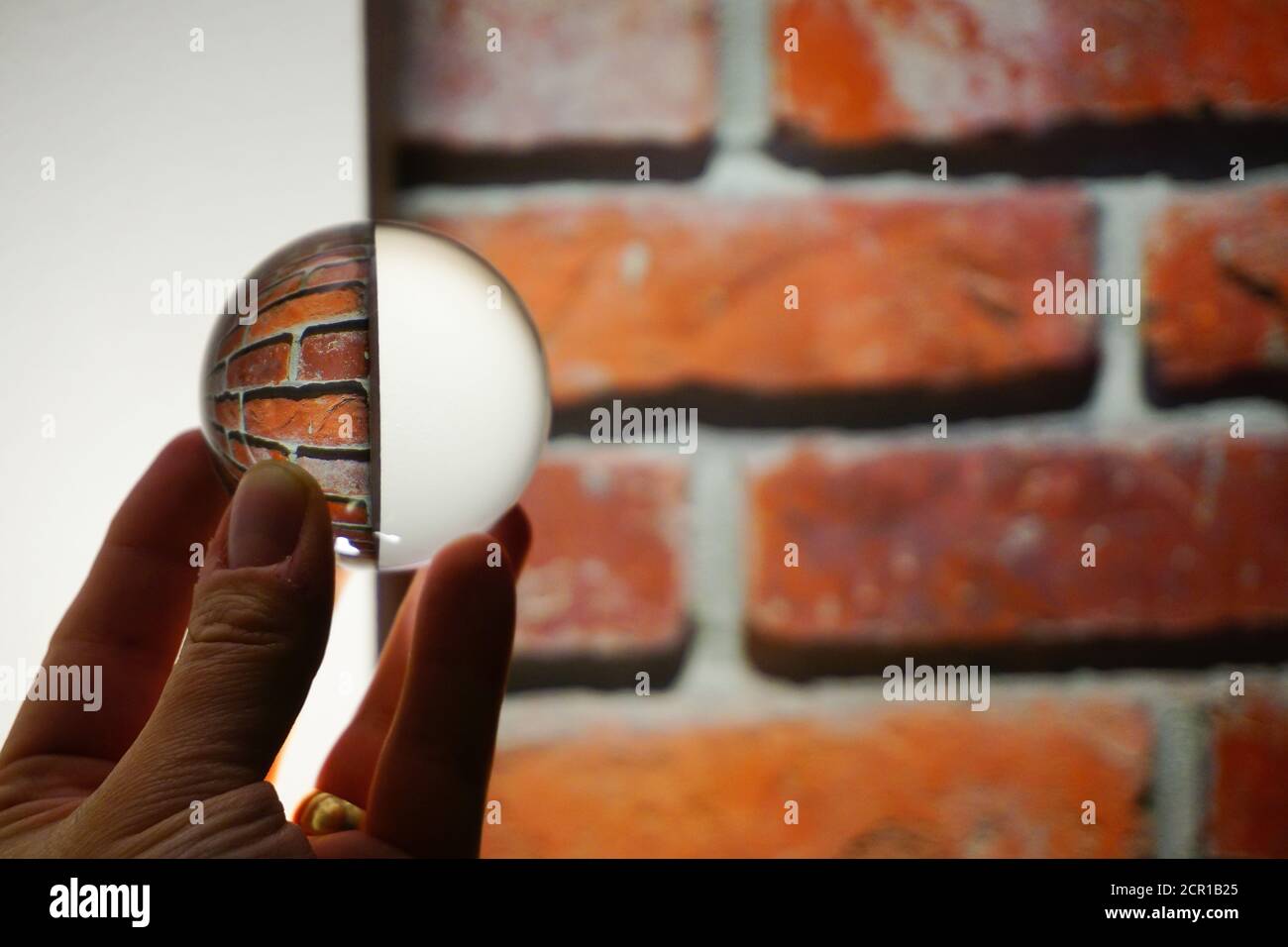 Glass sphere with reverse reflection in hand Stock Photo - Alamy