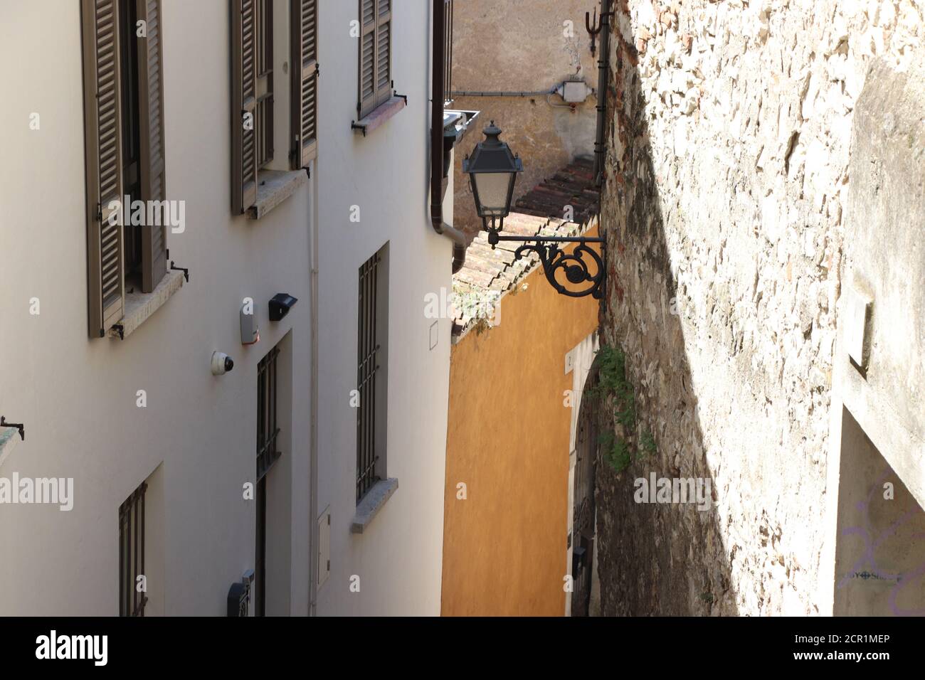 Typical italian street with old colorful buildings with shutter windows ...