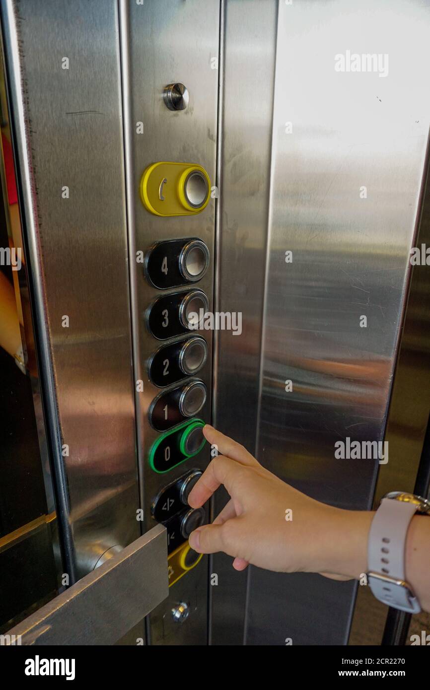 Woman hand on the elevator button close up view Stock Photo - Alamy