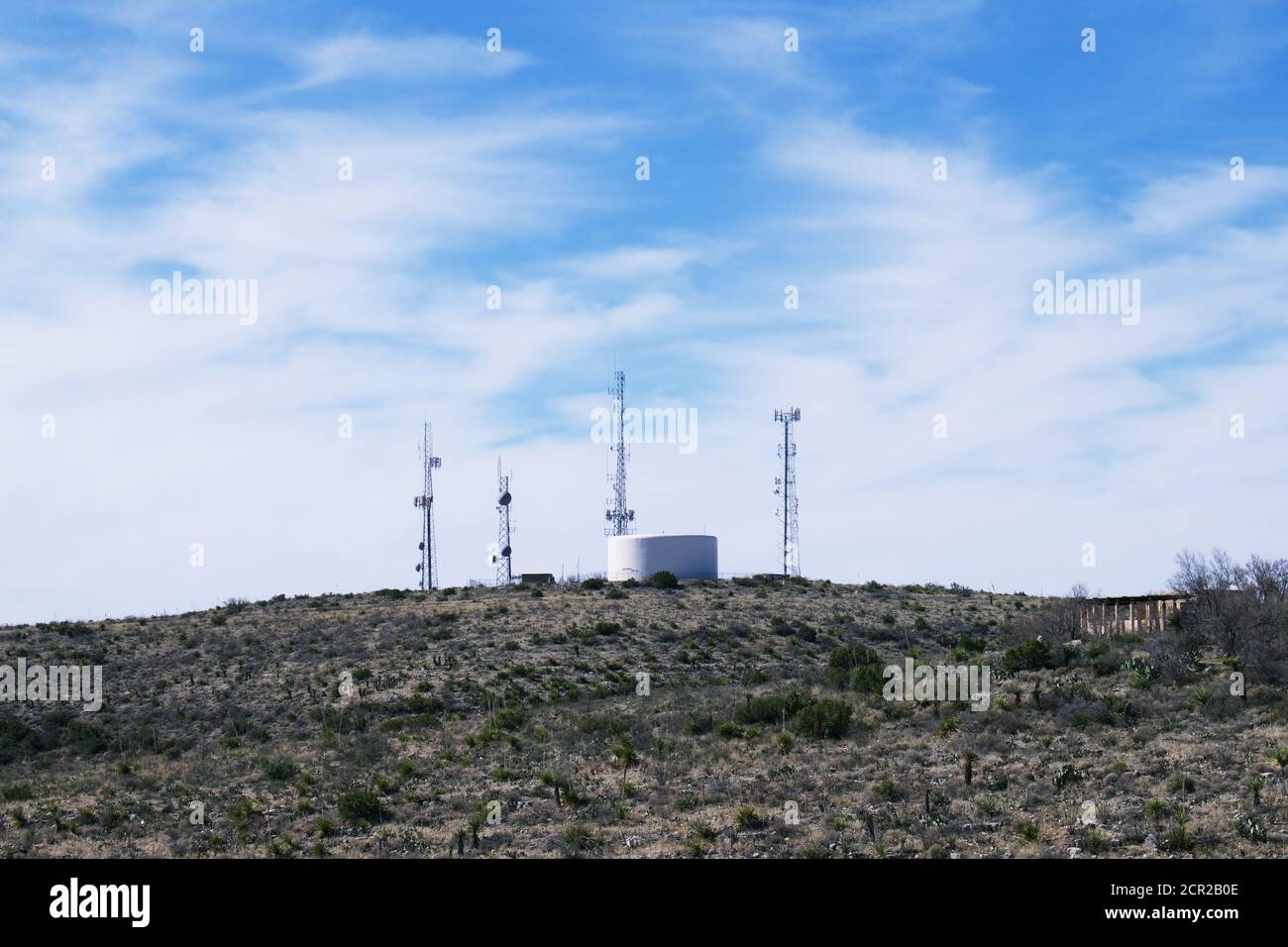 Communications towers on hill with blue sky Stock Photo - Alamy