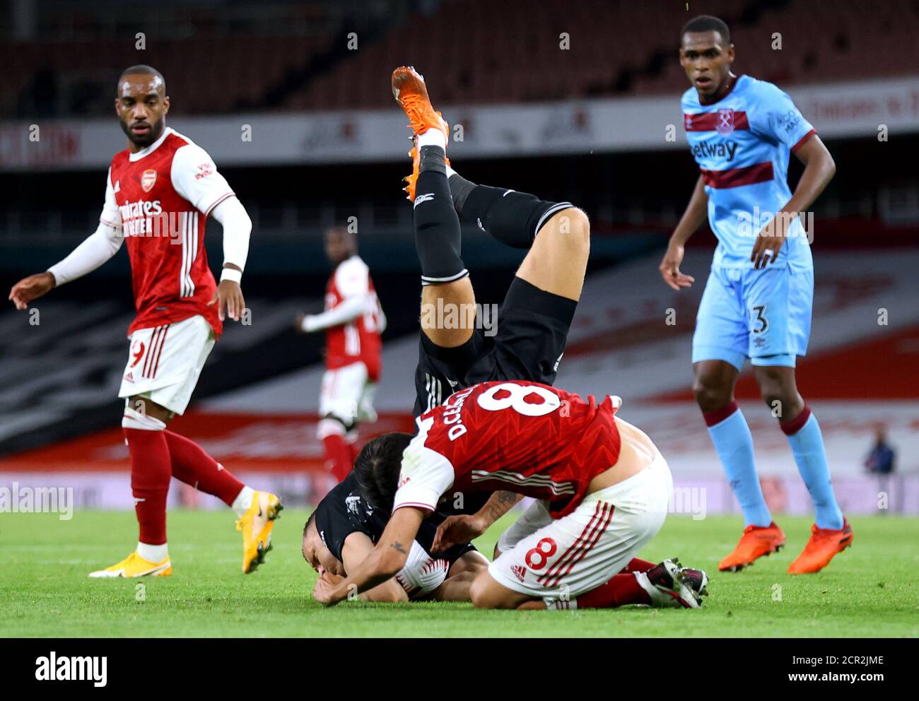 Arsenal goalkeeper Bernd Leno (upside down) and teammate Dani Ceballos ...