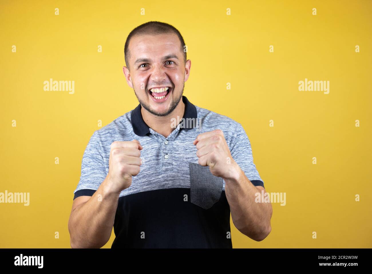 Russian man standing over insolated yellow background very happy and ...