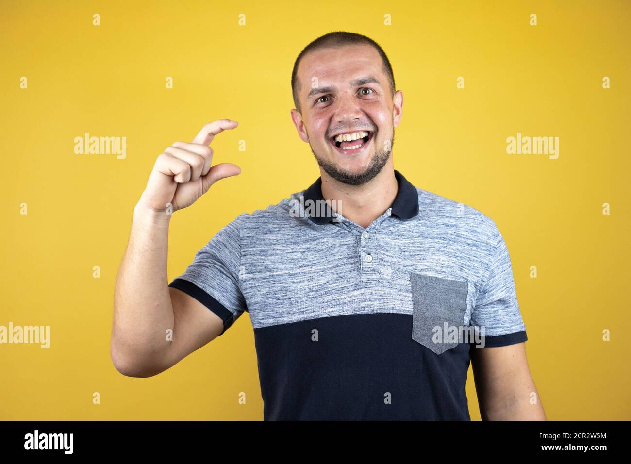 Russian man standing over insolated yellow background with hand doing ...