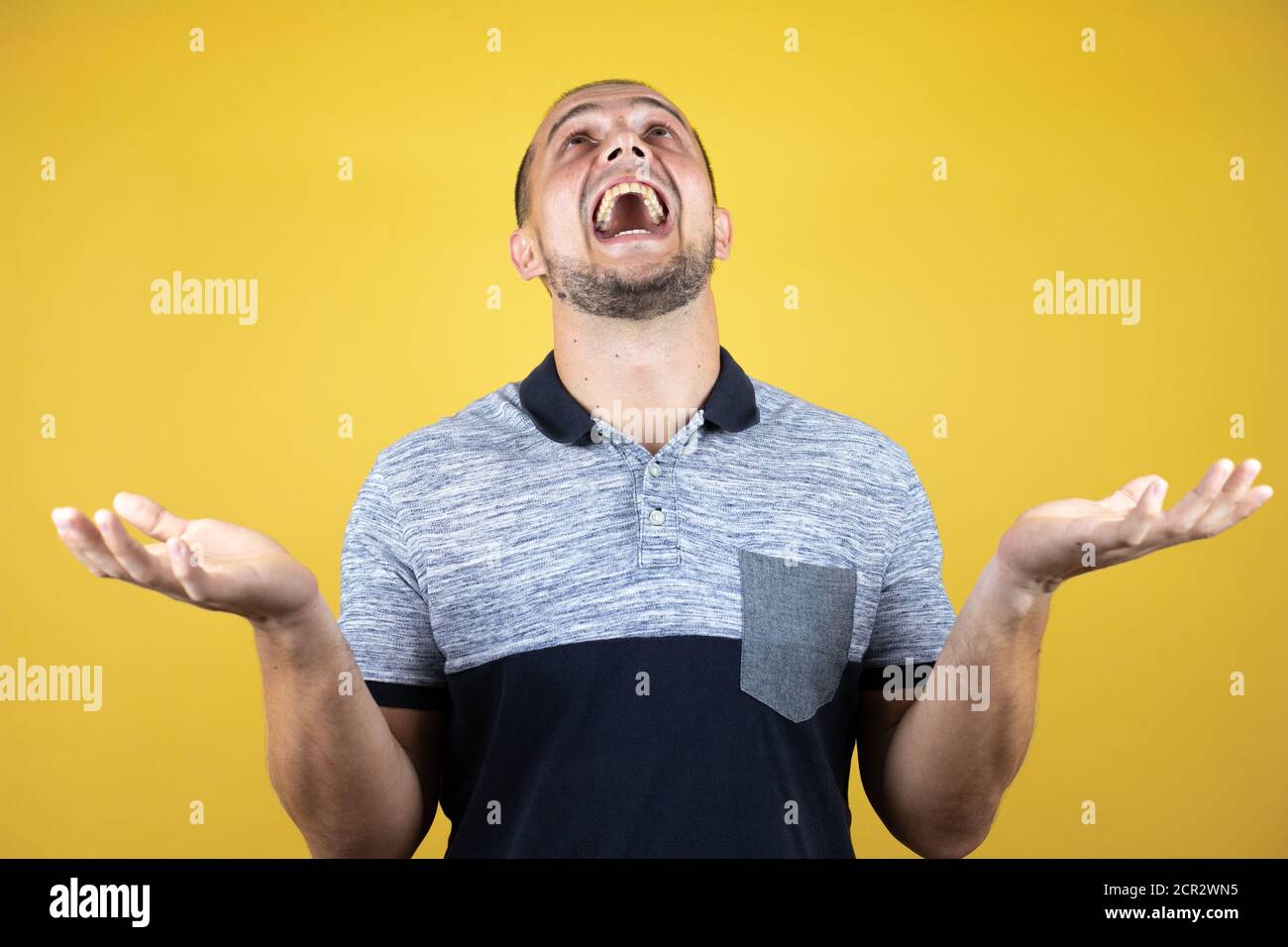 Russian man standing over insolated yellow background clueless and ...