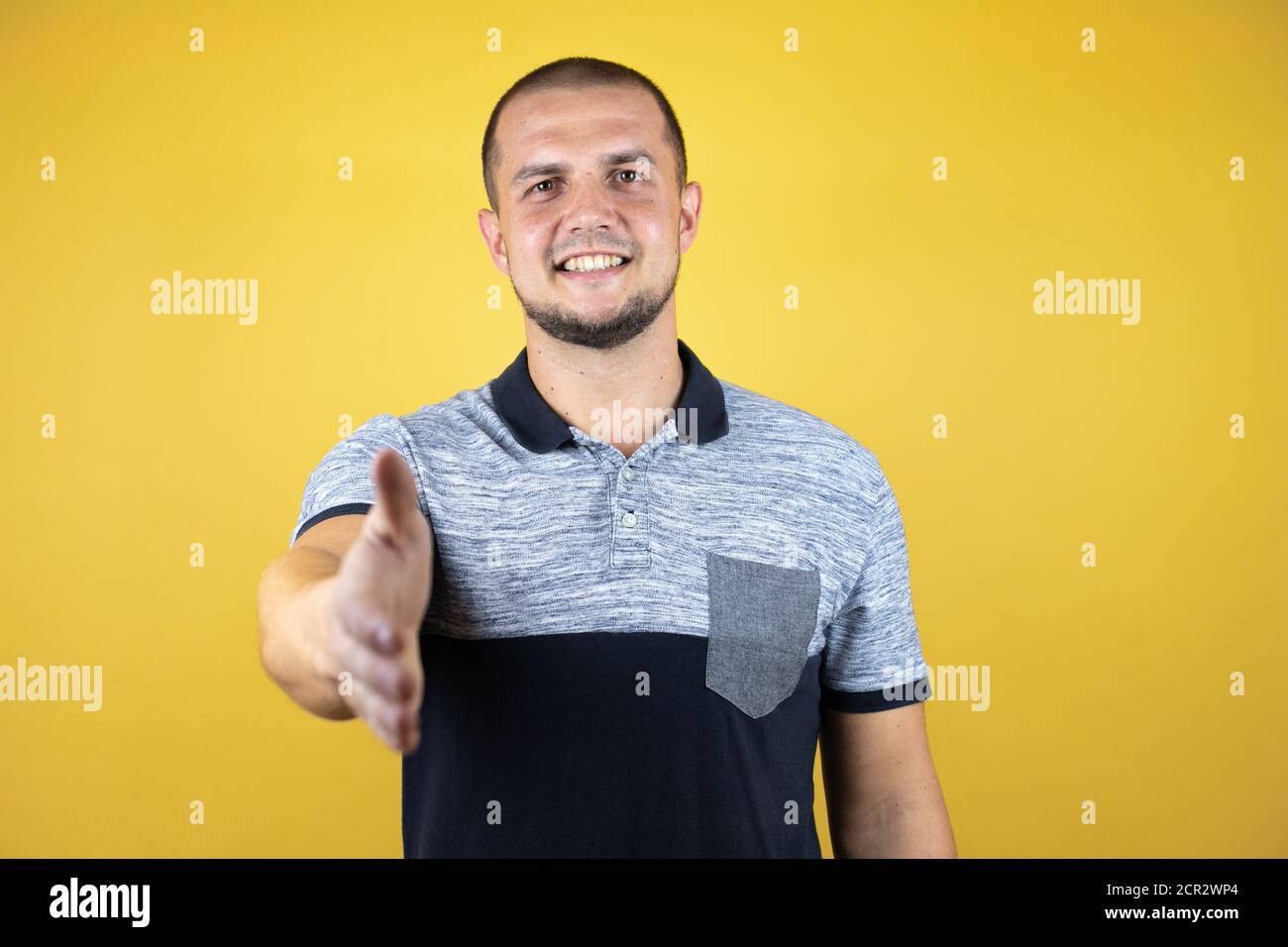Russian man standing over insolated yellow background smiling friendly ...
