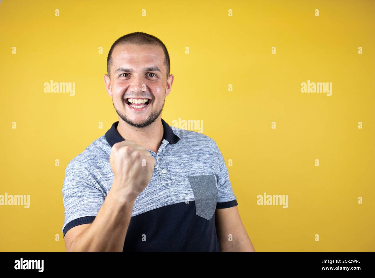 Russian man standing over insolated yellow background very happy and ...