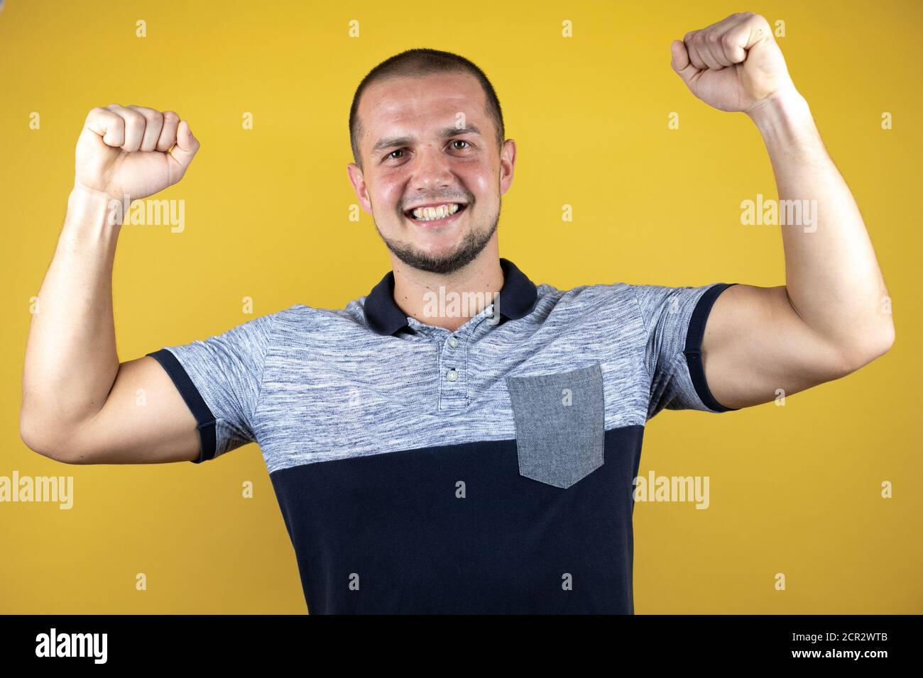 Russian man standing over insolated yellow background showing arms ...