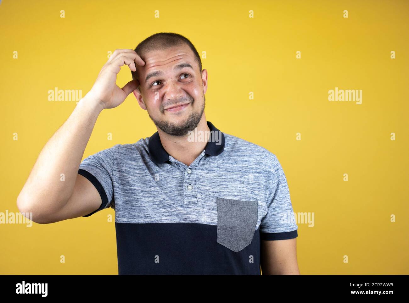 Russian man standing over insolated yellow background putting one hand ...