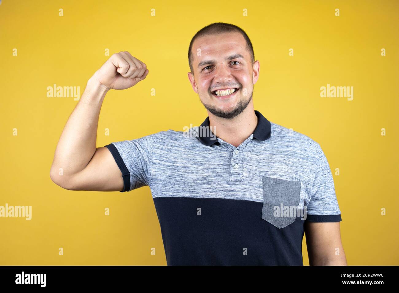 Russian man standing over insolated yellow background showing arms ...