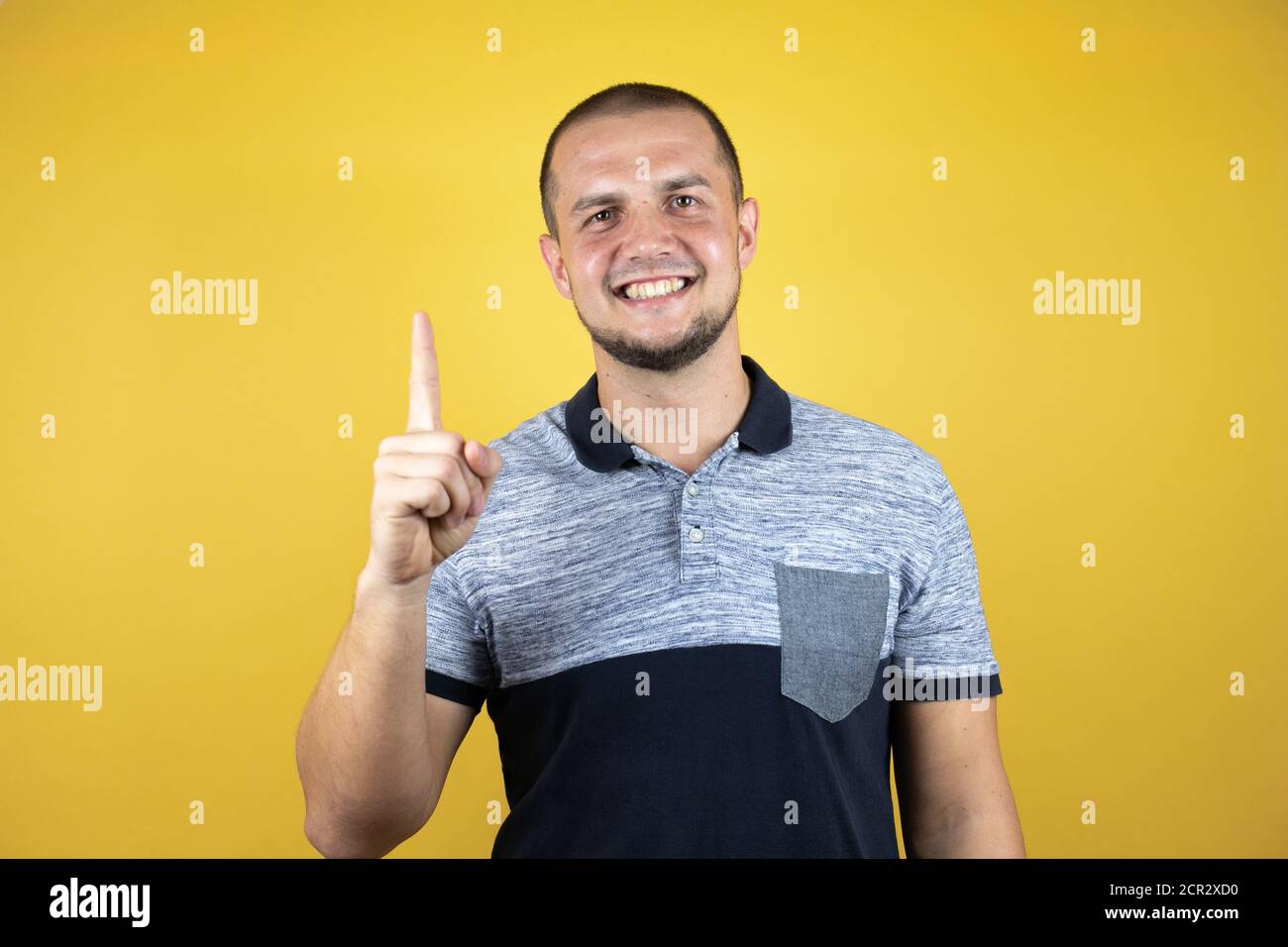 Russian man standing over insolated yellow background showing and ...