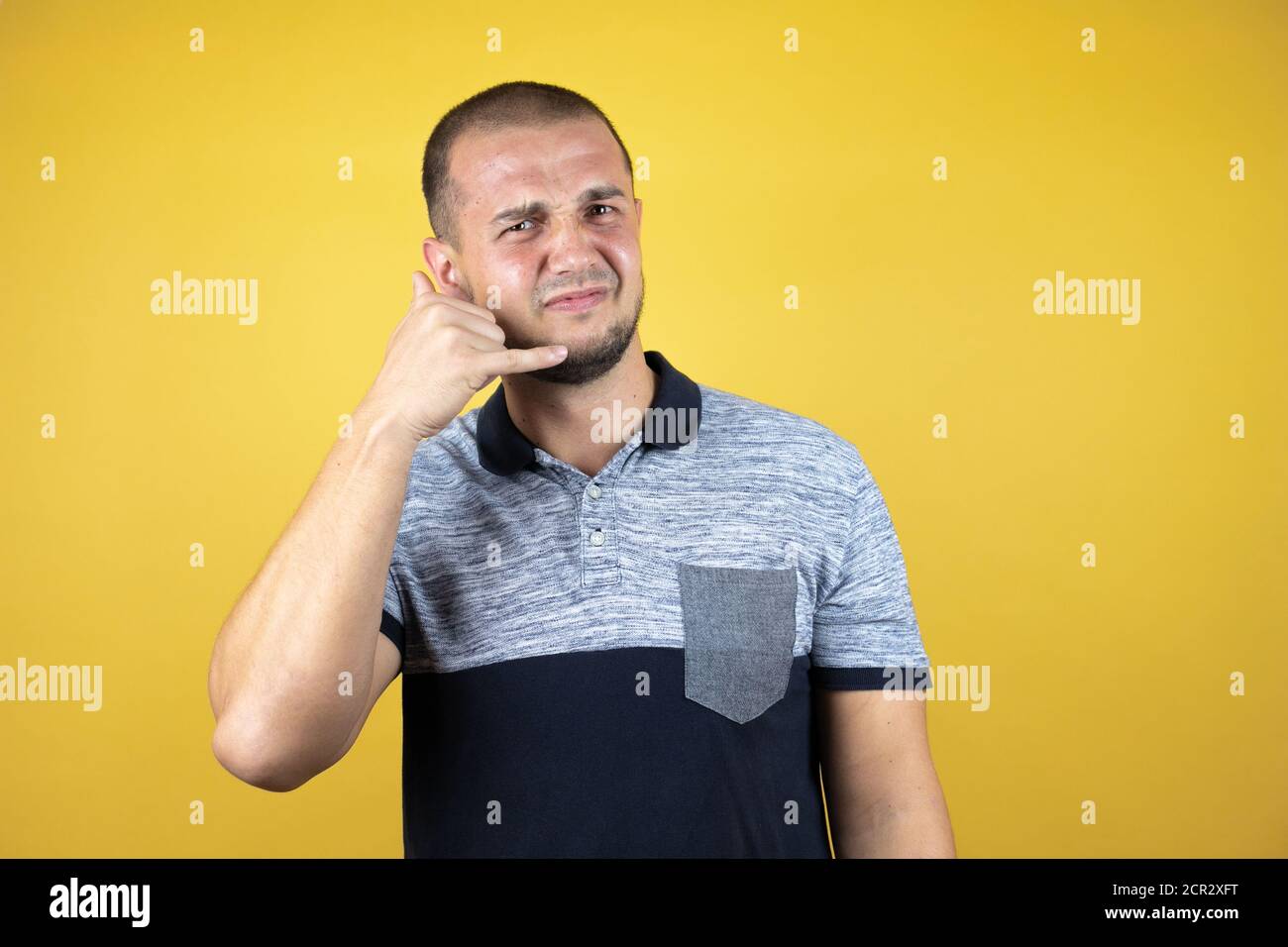 Russian man standing over insolated yellow background smiling doing ...
