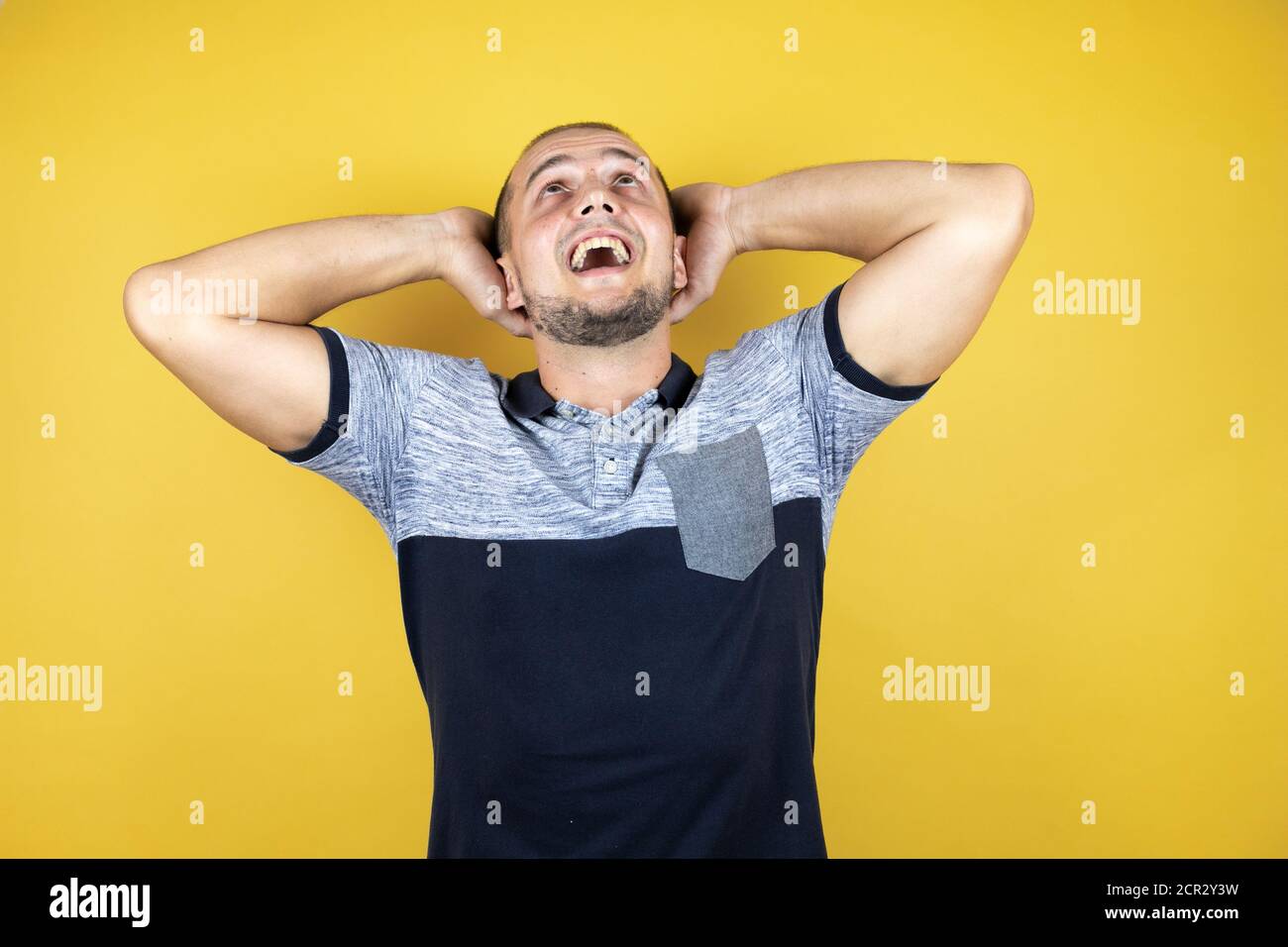 Russian man standing over insolated yellow background relaxing and ...