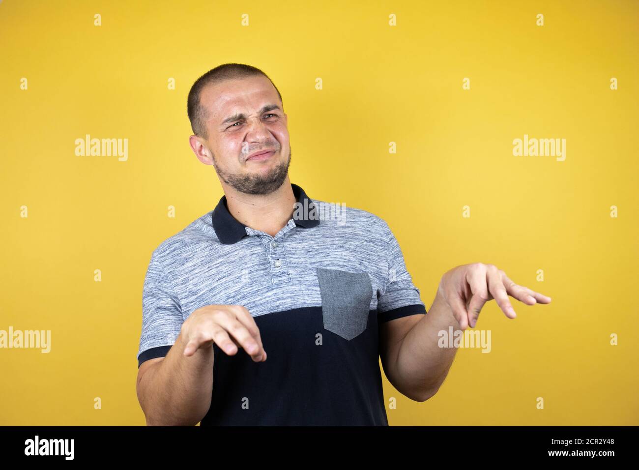 Russian man standing over insolated yellow background disgusted ...