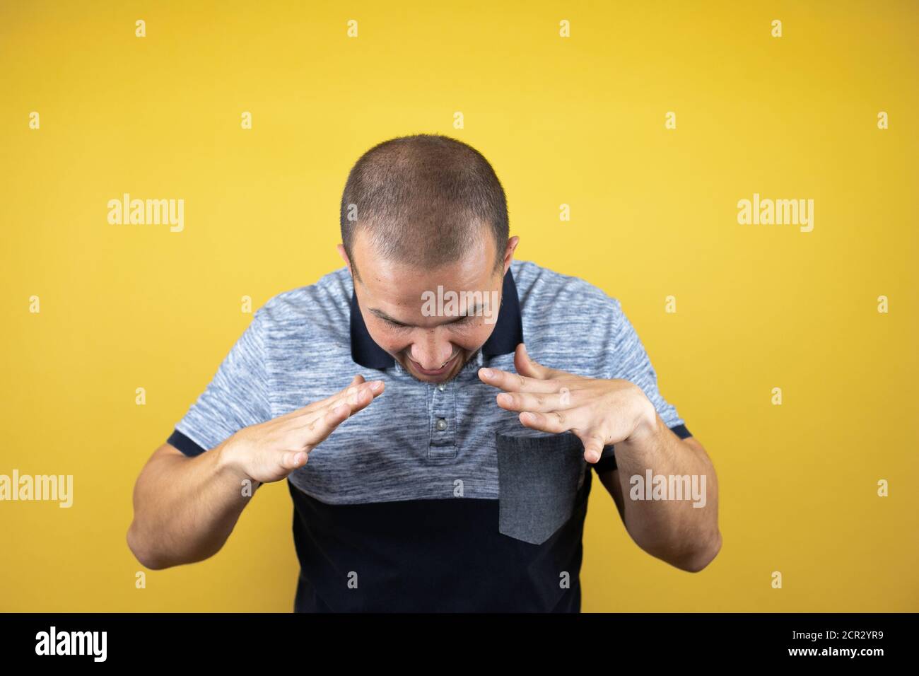 Russian man standing over insolated yellow background shouting and ...