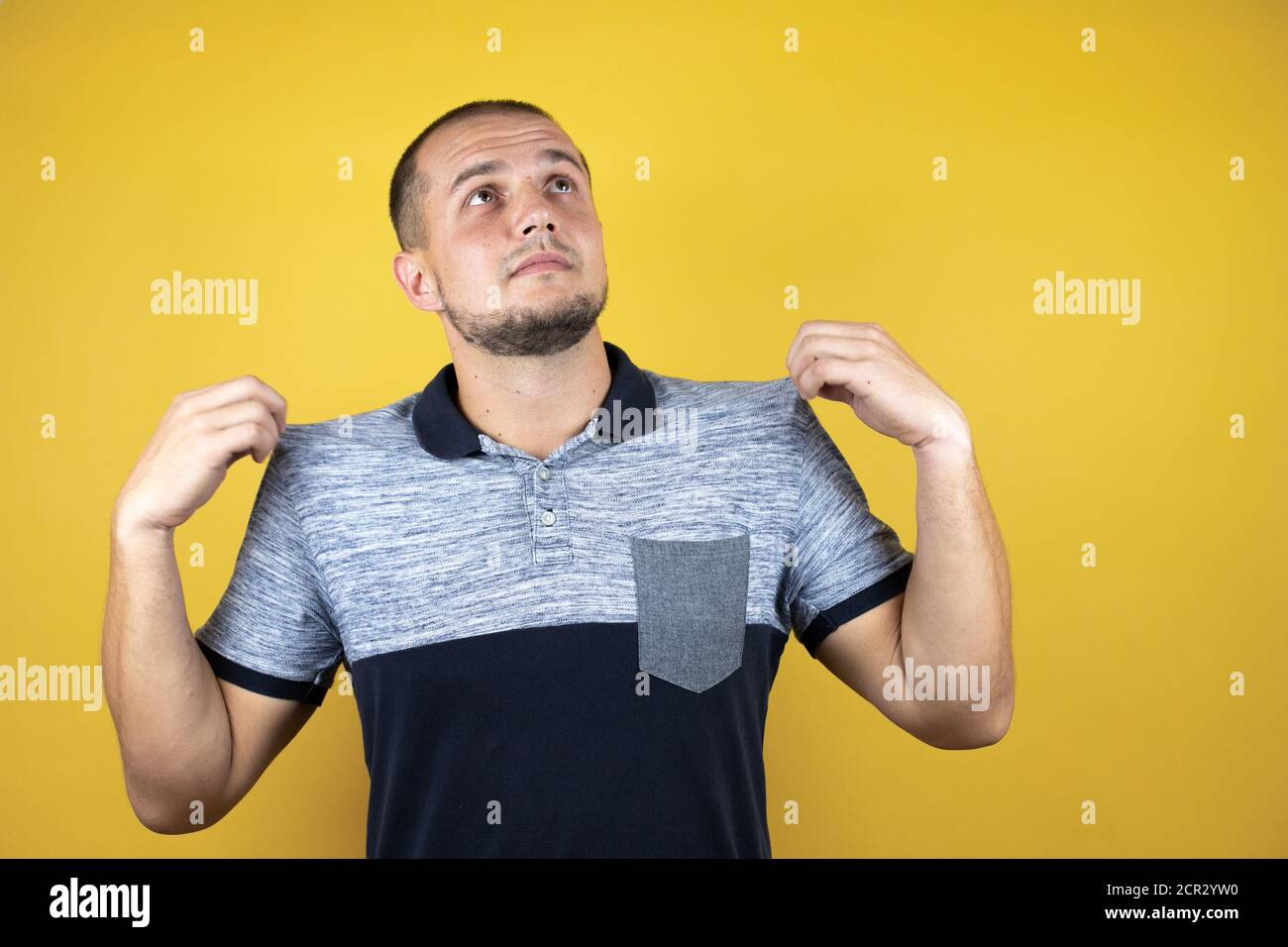 Russian man standing over insolated yellow background with a successful ...