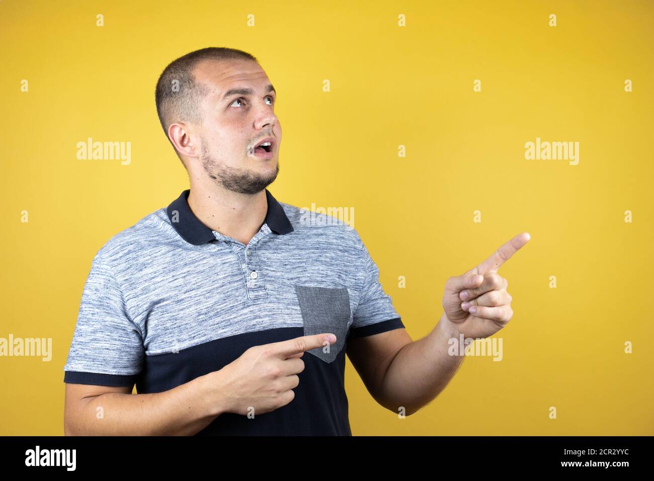 Russian man standing over insolated yellow background smiling with ...