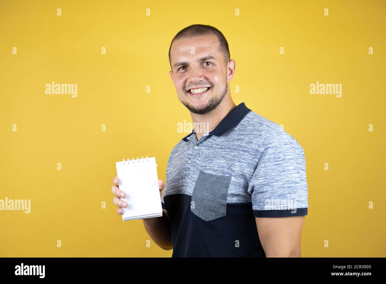Russian man standing over insolated yellow background smiling and ...