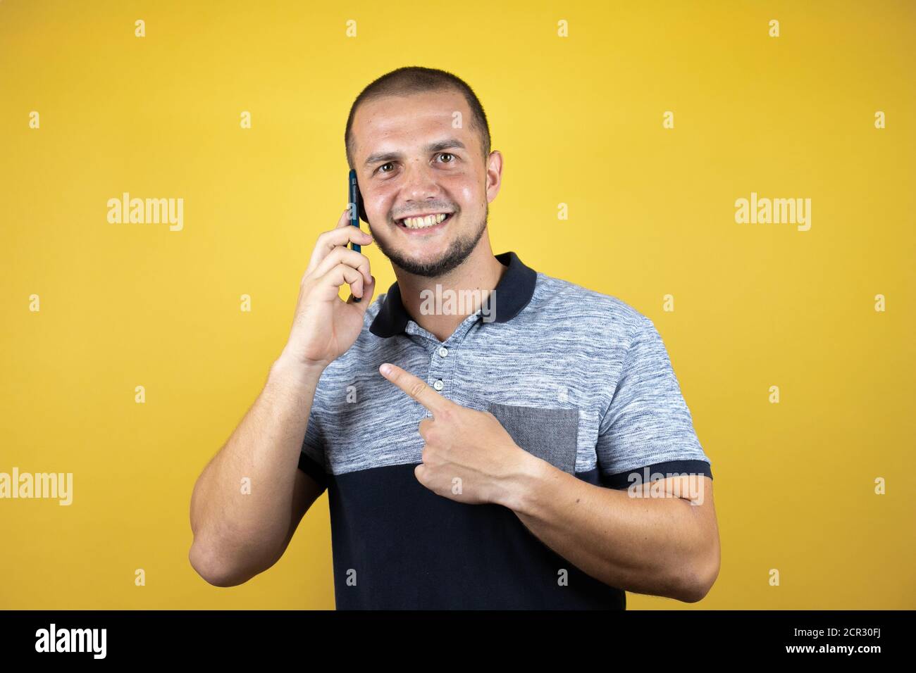 Russian man standing over insolated yellow background having a ...