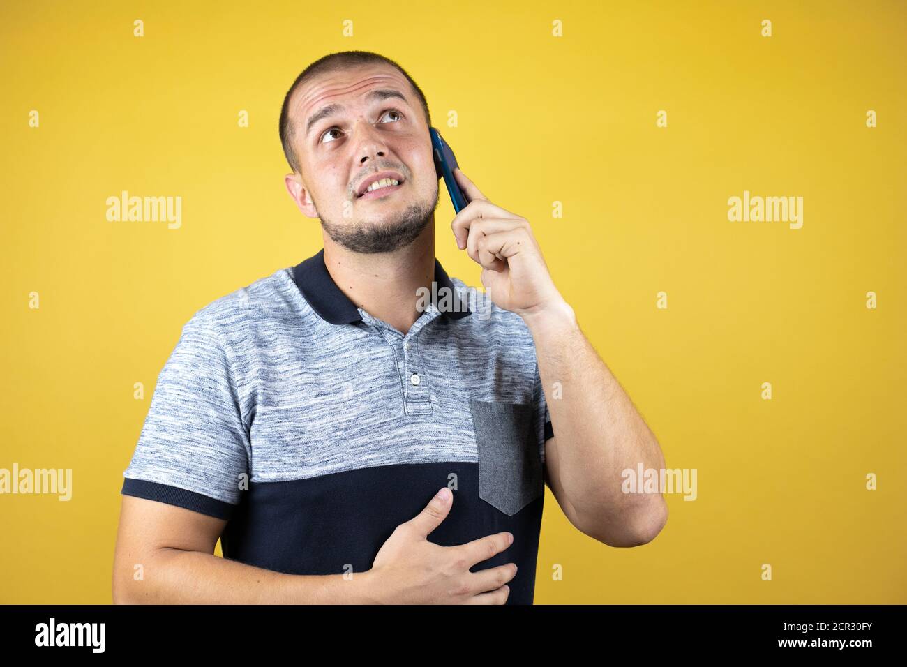 Russian man standing over insolated yellow background having a ...