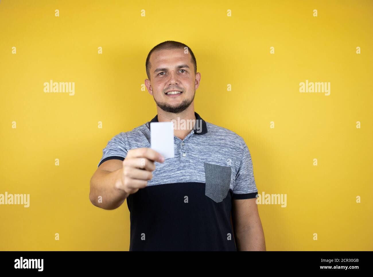 Russian man standing over insolated yellow background showing a white ...
