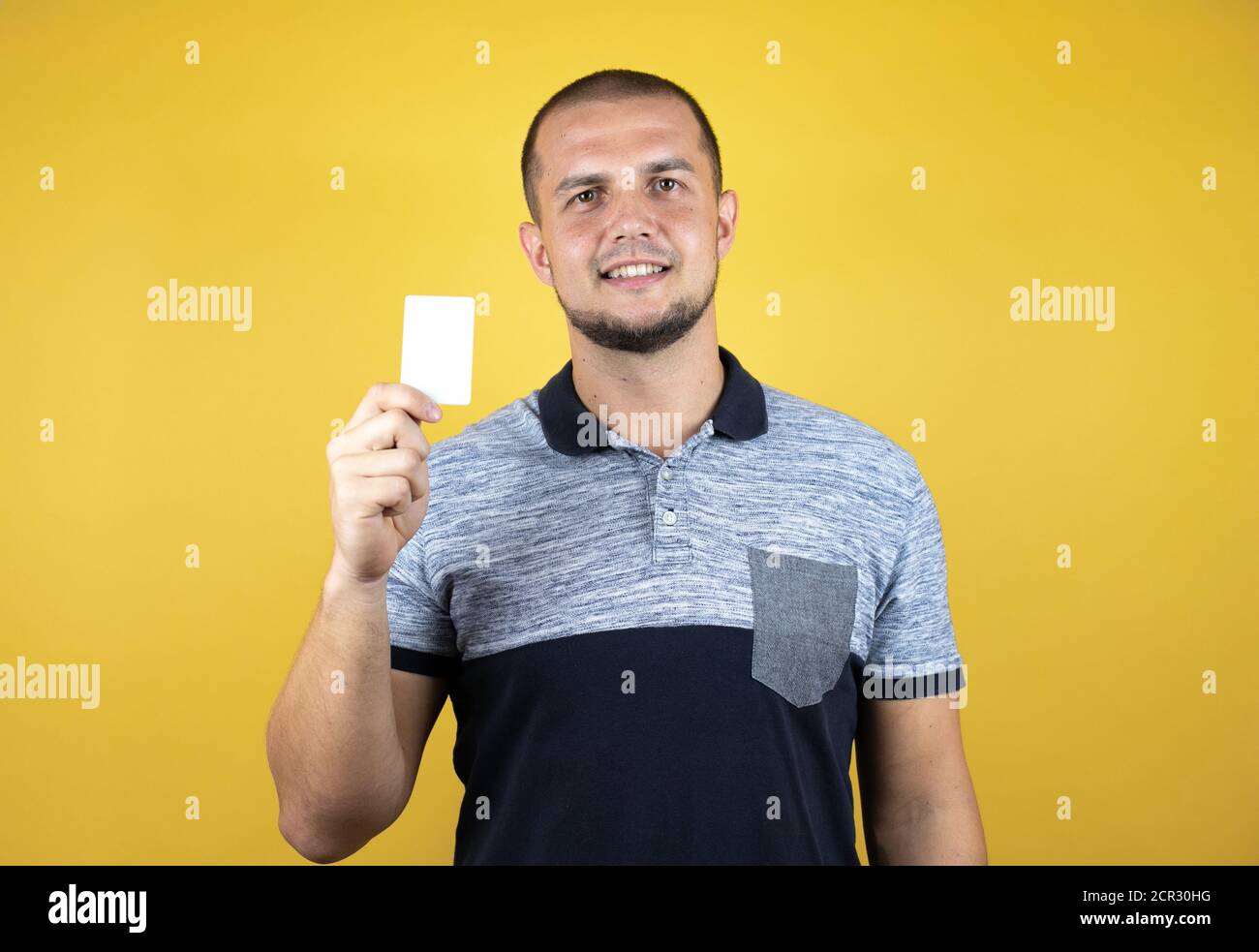 Russian man standing over insolated yellow background showing a white ...