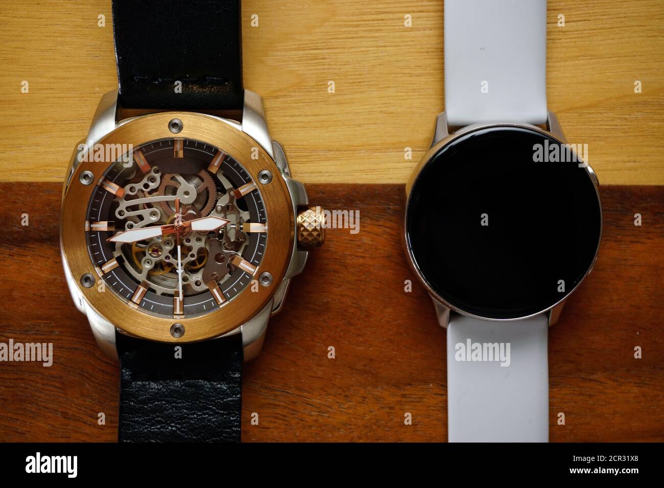 Analog and smart watches on wooden background with copyspace Stock ...