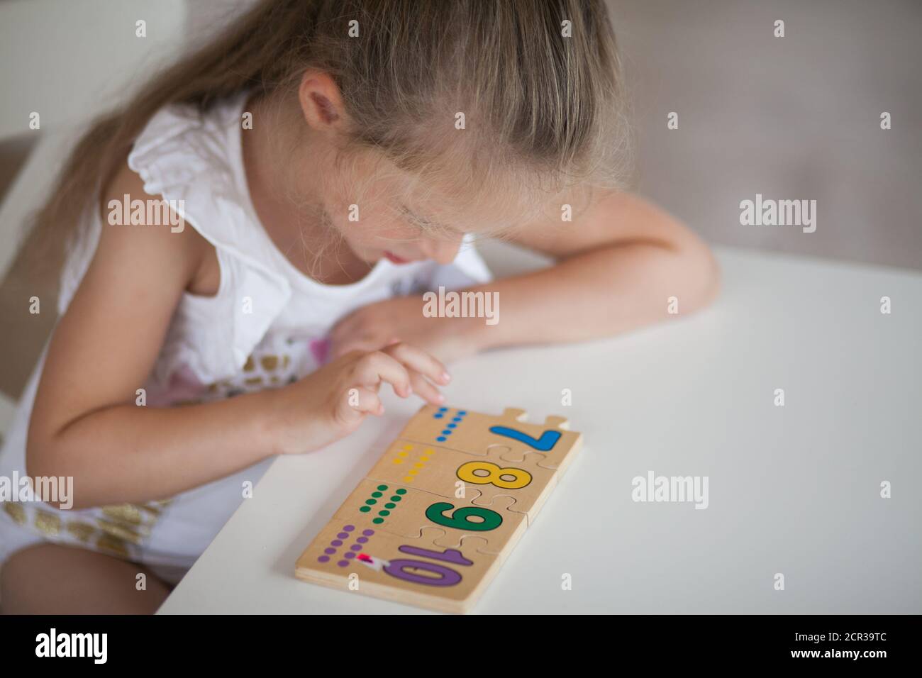 Little cute preschooler child girl playing educational games with ...