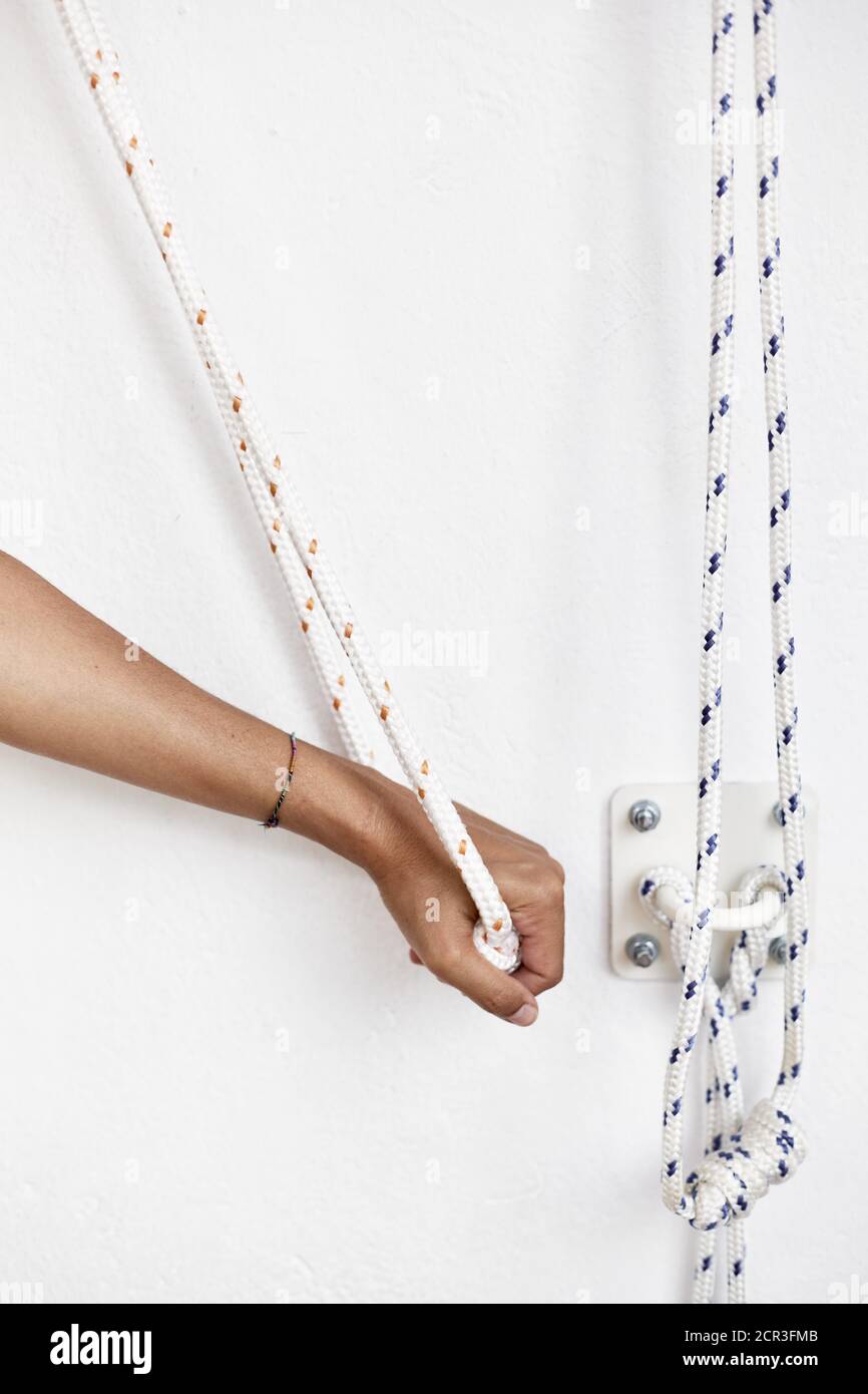 Closeup hands holding the rope, iyengar yoga at studio, stretching with ...