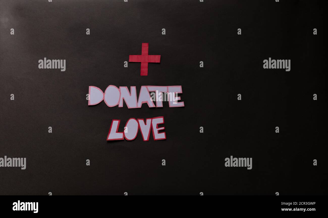 Paper cutouts of letters that reads DONATE LOVE- concept of blood and ...