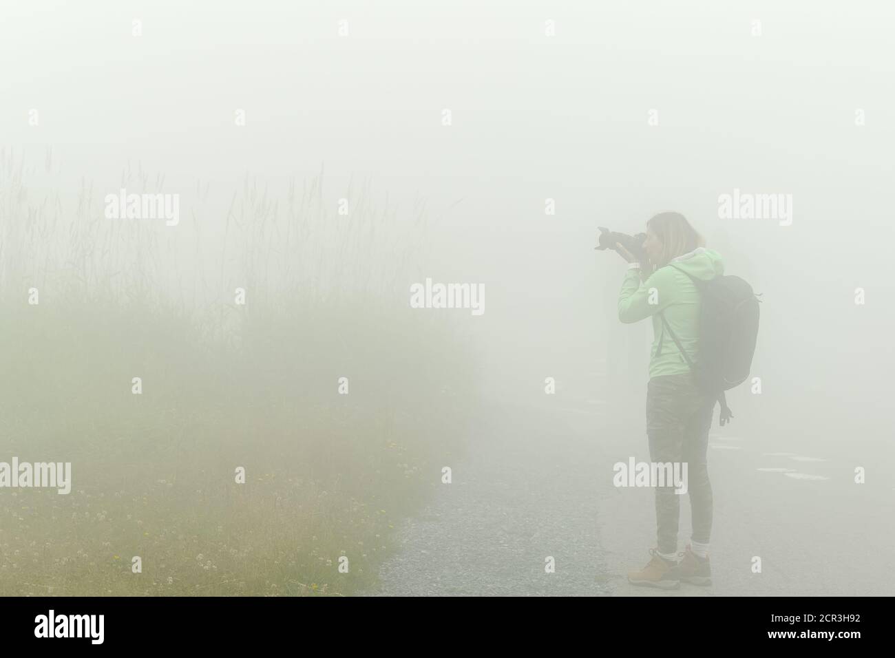 Female hiker photographing with her digital camera of the fall ...