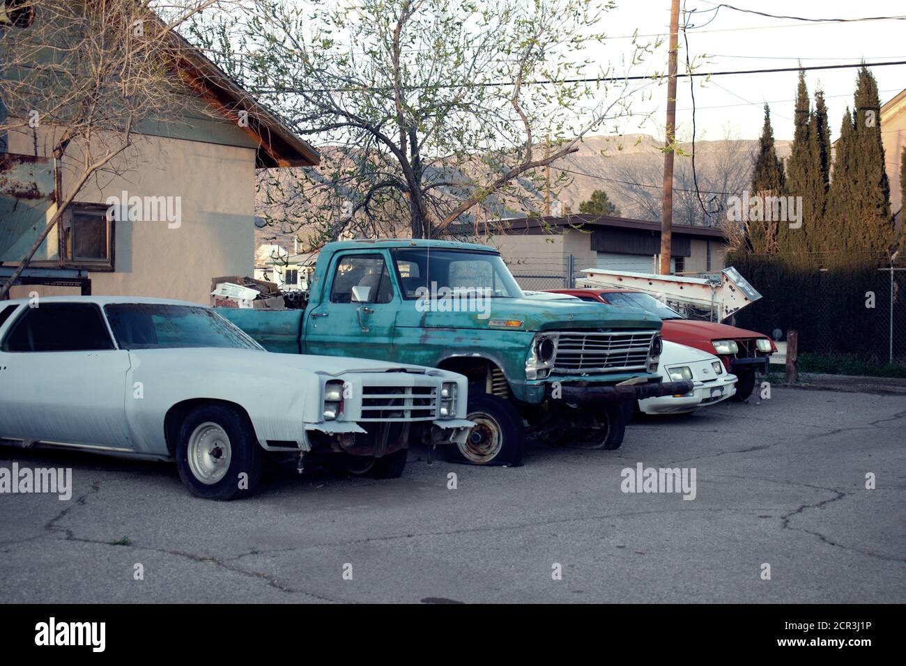Row of broken-down cars in a garage parking lot Stock Photo - Alamy
