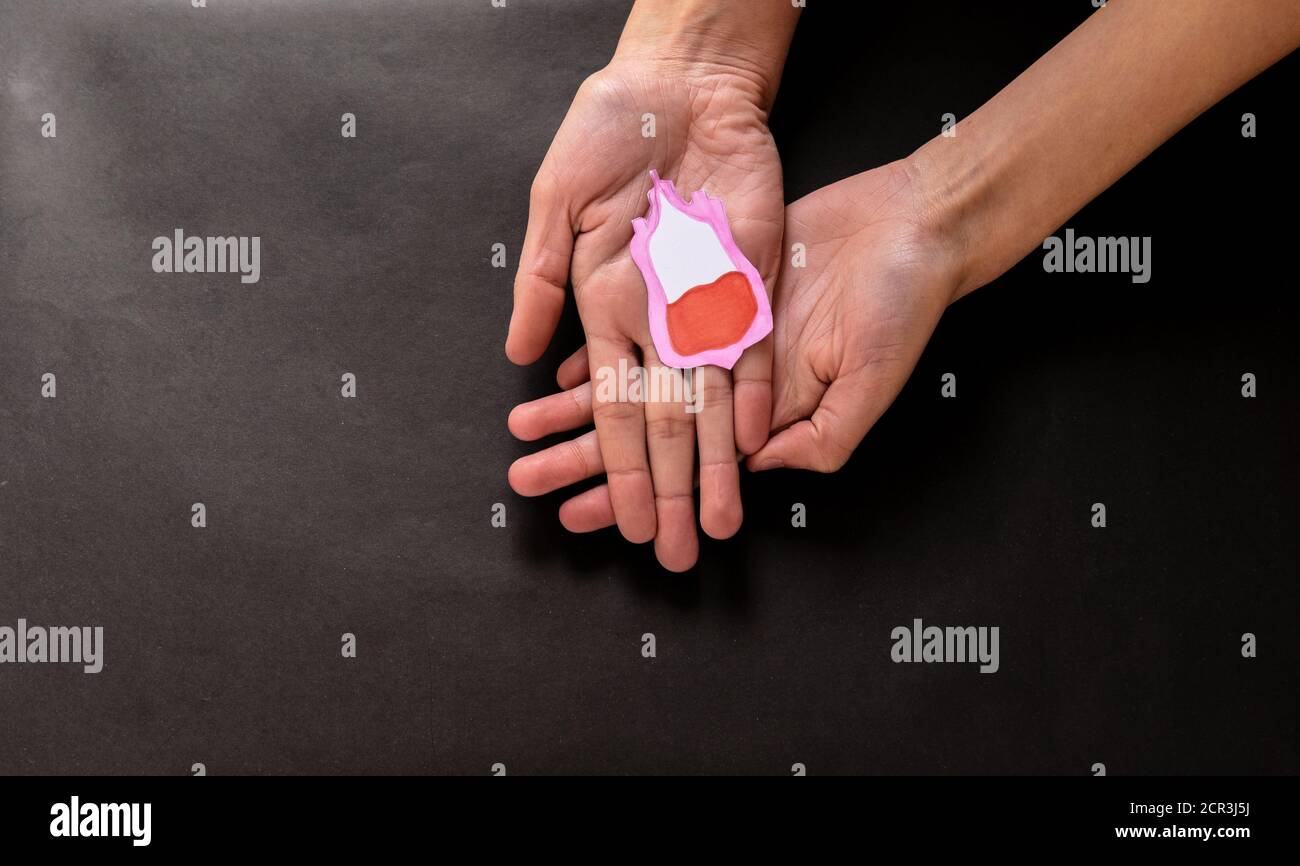Paper cutout of a bag of blood on a person's hands - concept of blood ...