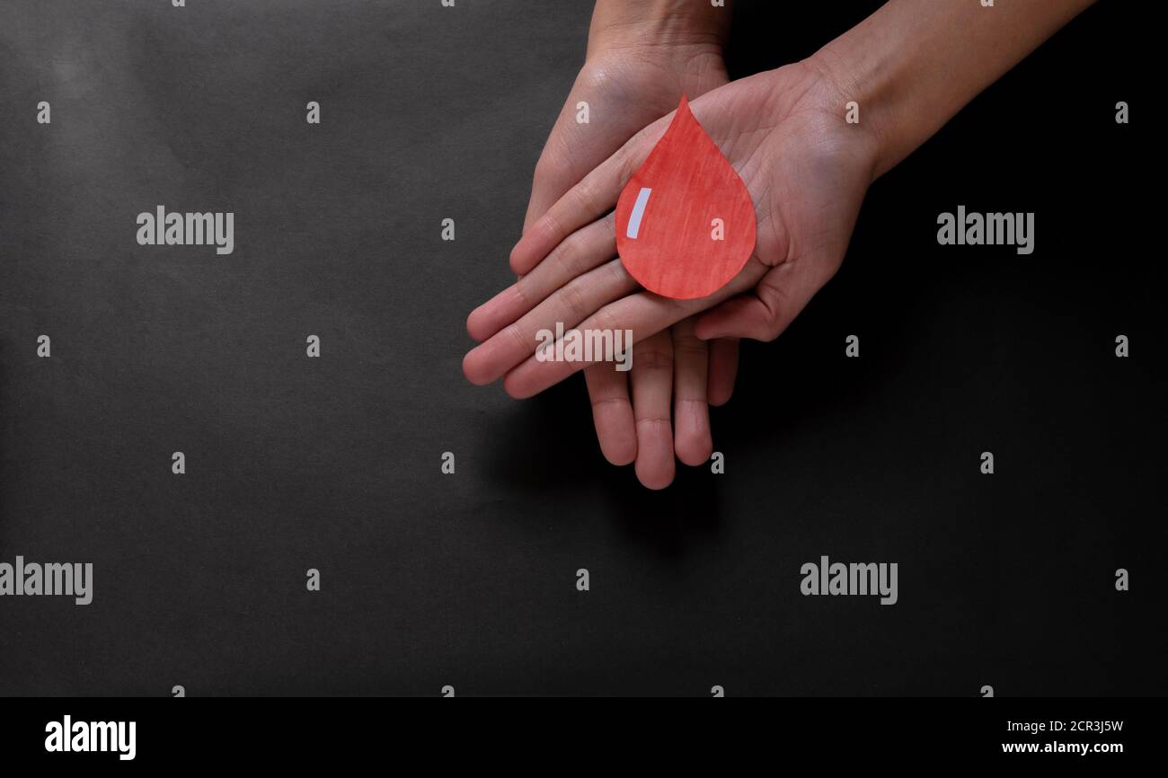 Paper cutout of a bag of blood on a person's hands - concept of blood ...