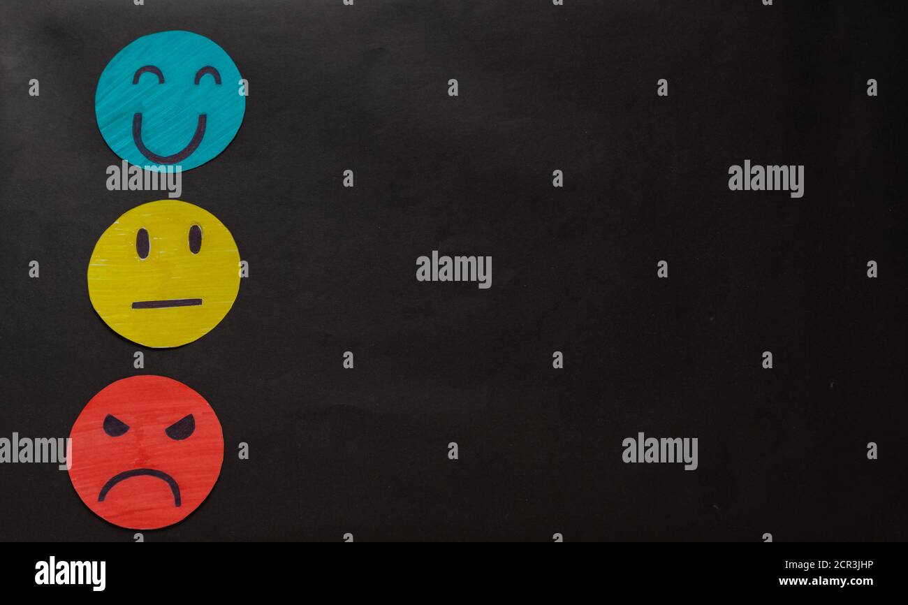 Overhead shot of a paper cutouts of faces representing satisfactory ...