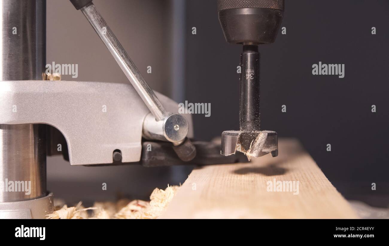 Boring machine and wood at table, close up Stock Photo - Alamy