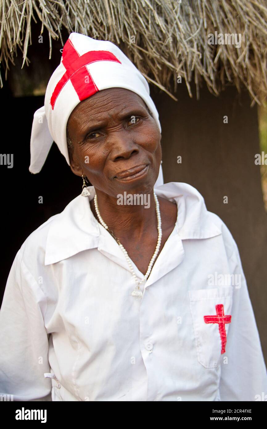 Elderly woman is native healer for village and poses in her nurse ...