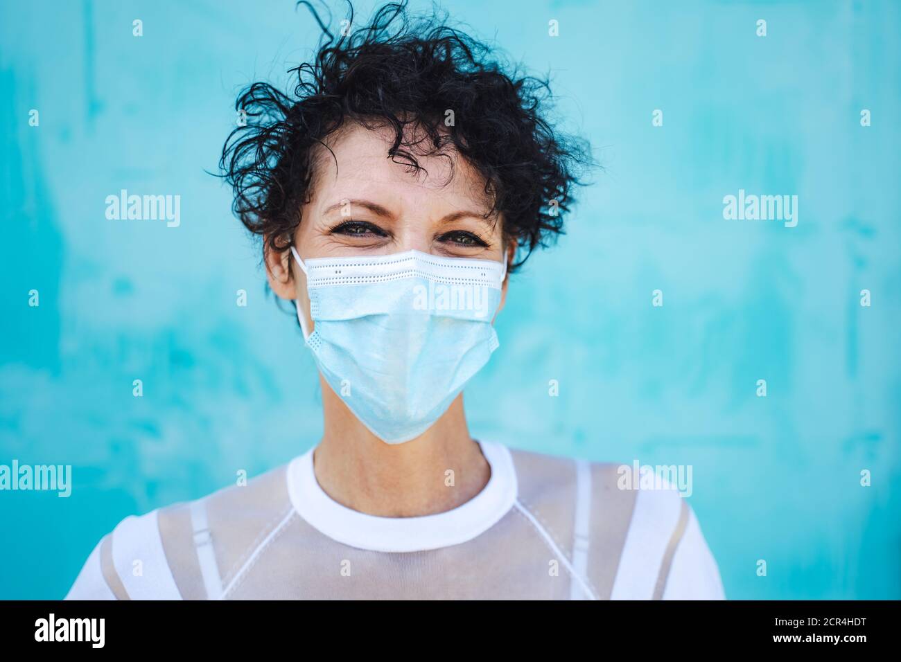 Close up portrait of mature woman with curly short hair wearing safety ...
