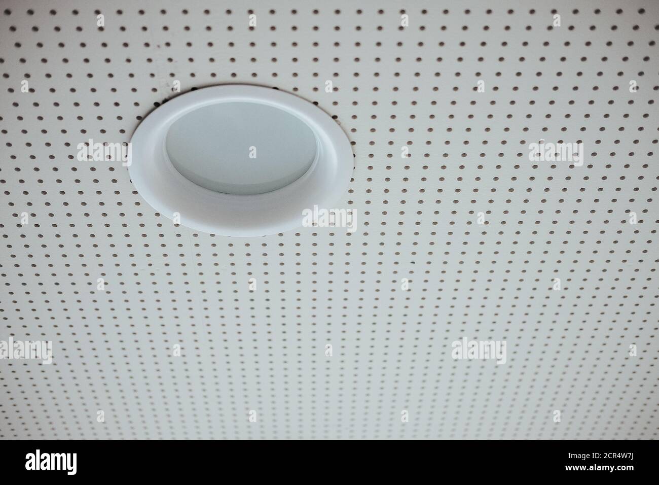 Closeup of dotted ceiling tiles Stock Photo - Alamy