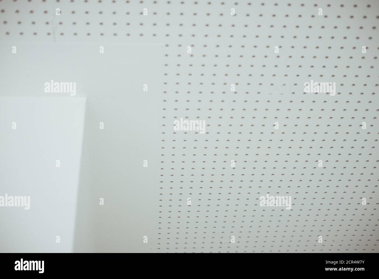 Closeup of dotted ceiling tiles Stock Photo - Alamy
