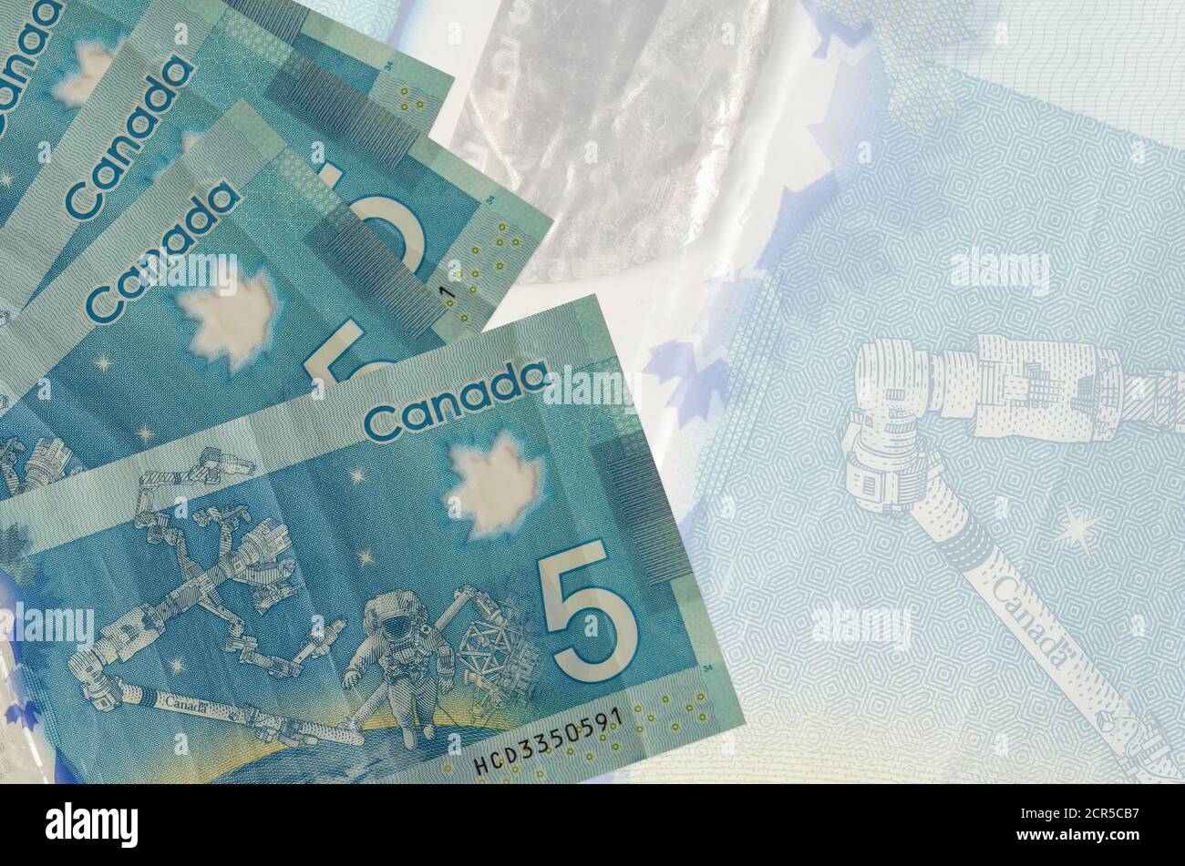 5 Canadian dollars bills lies in stack on background of big semi ...