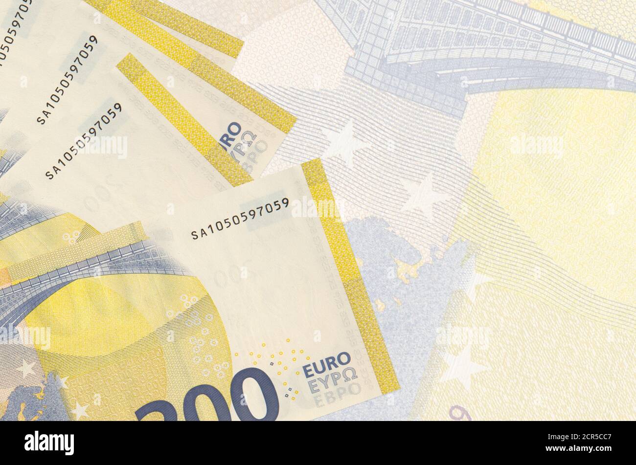 200 euro bills lies in stack on background of big semi-transparent ...