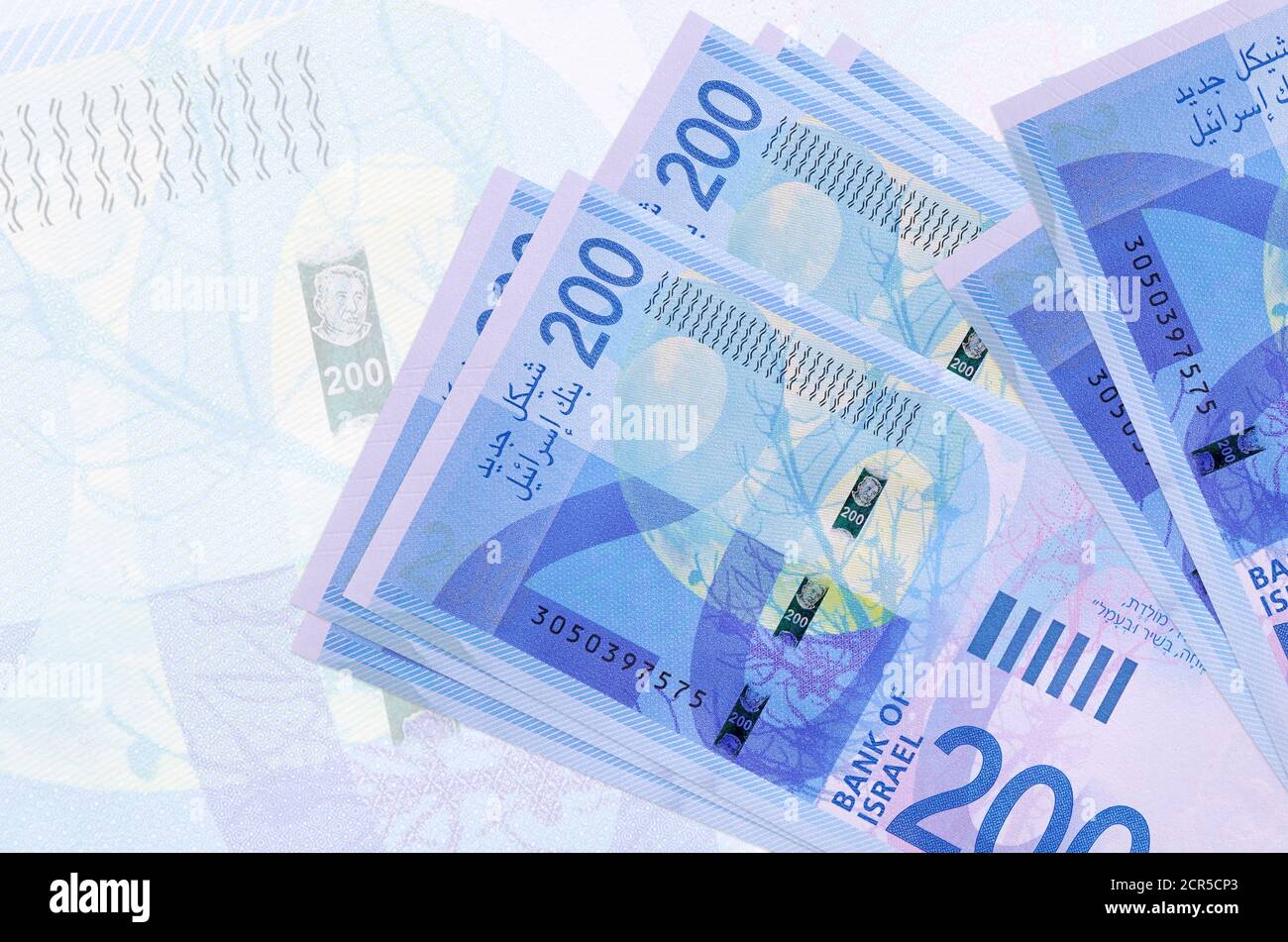 200 Israeli new shekels bills lies in stack on background of big semi ...