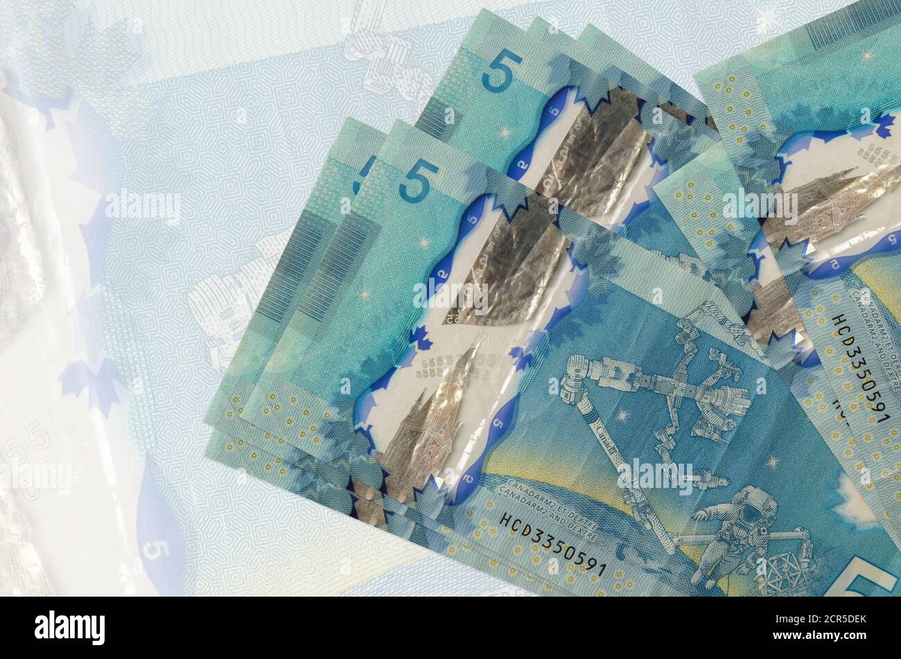 5 Canadian dollars bills lies in stack on background of big semi ...